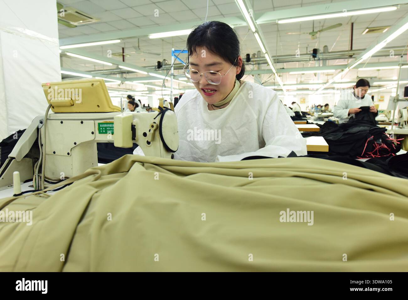 Workers produce export garments at a company in Qinghu Town, Donghai ...