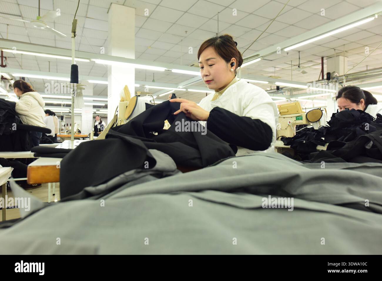 Workers produce export garments at a company in Qinghu Town, Donghai ...