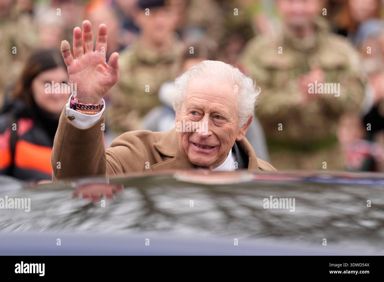 King Charles III waves following his visit to the Royal Regiment of ...