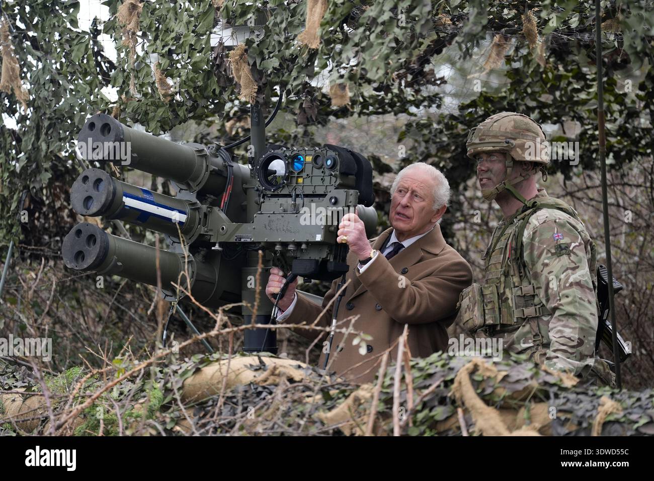 King Charles III views a lightweight multiple launcher during a visit ...