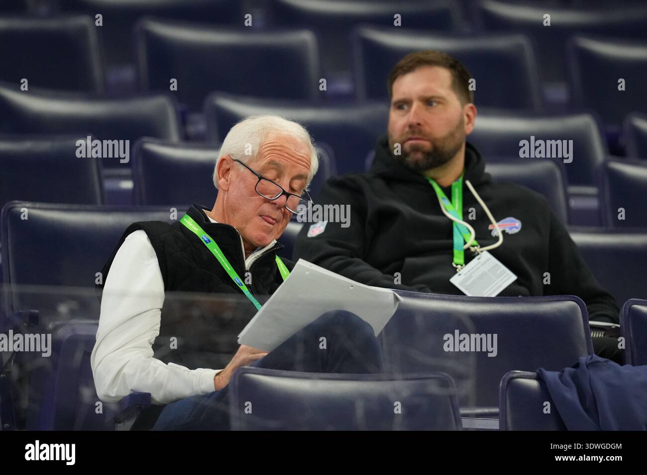 Scouts watch as players run drills at the NFL football scouting combine ...