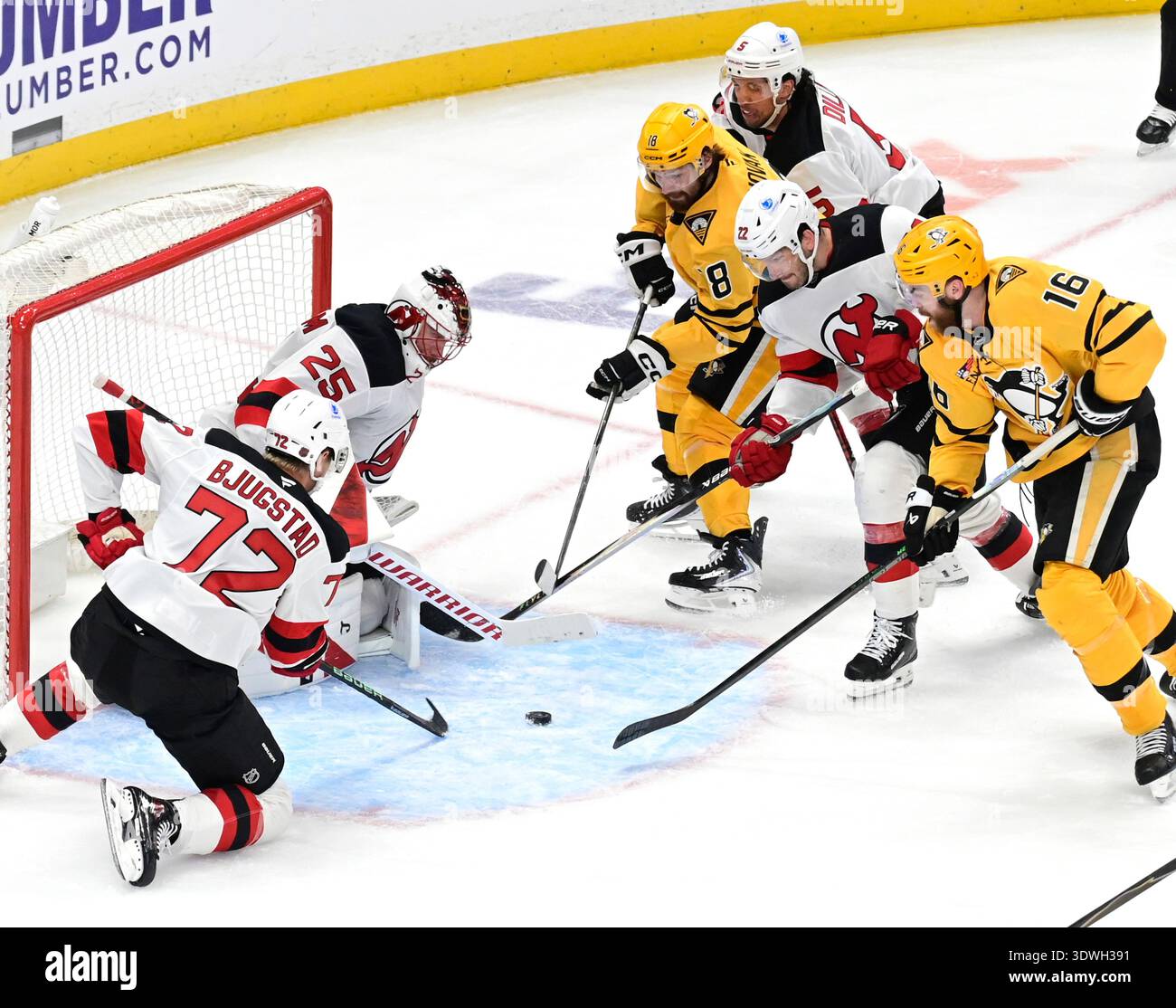 New Jersey Devils center Nick Bjugstad (72) clears away the puck the ...