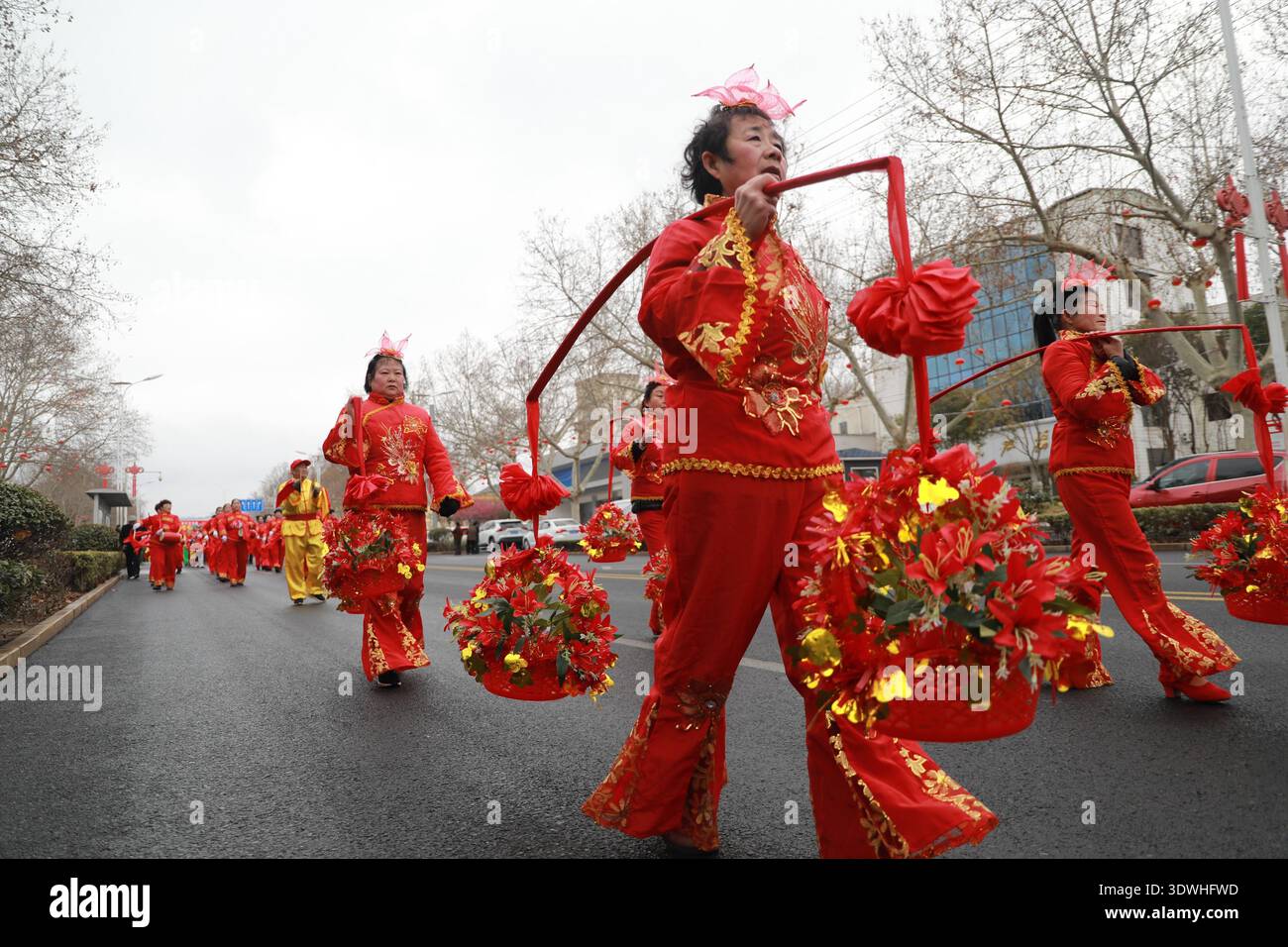 Farmers perform traditional dances during a Lunar New Year celebration ...