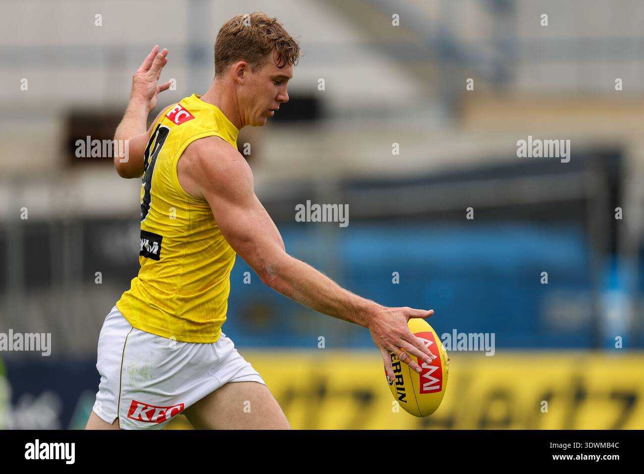 Tom Lynch of the Tigers kicks the ball during the AFL Community Series ...