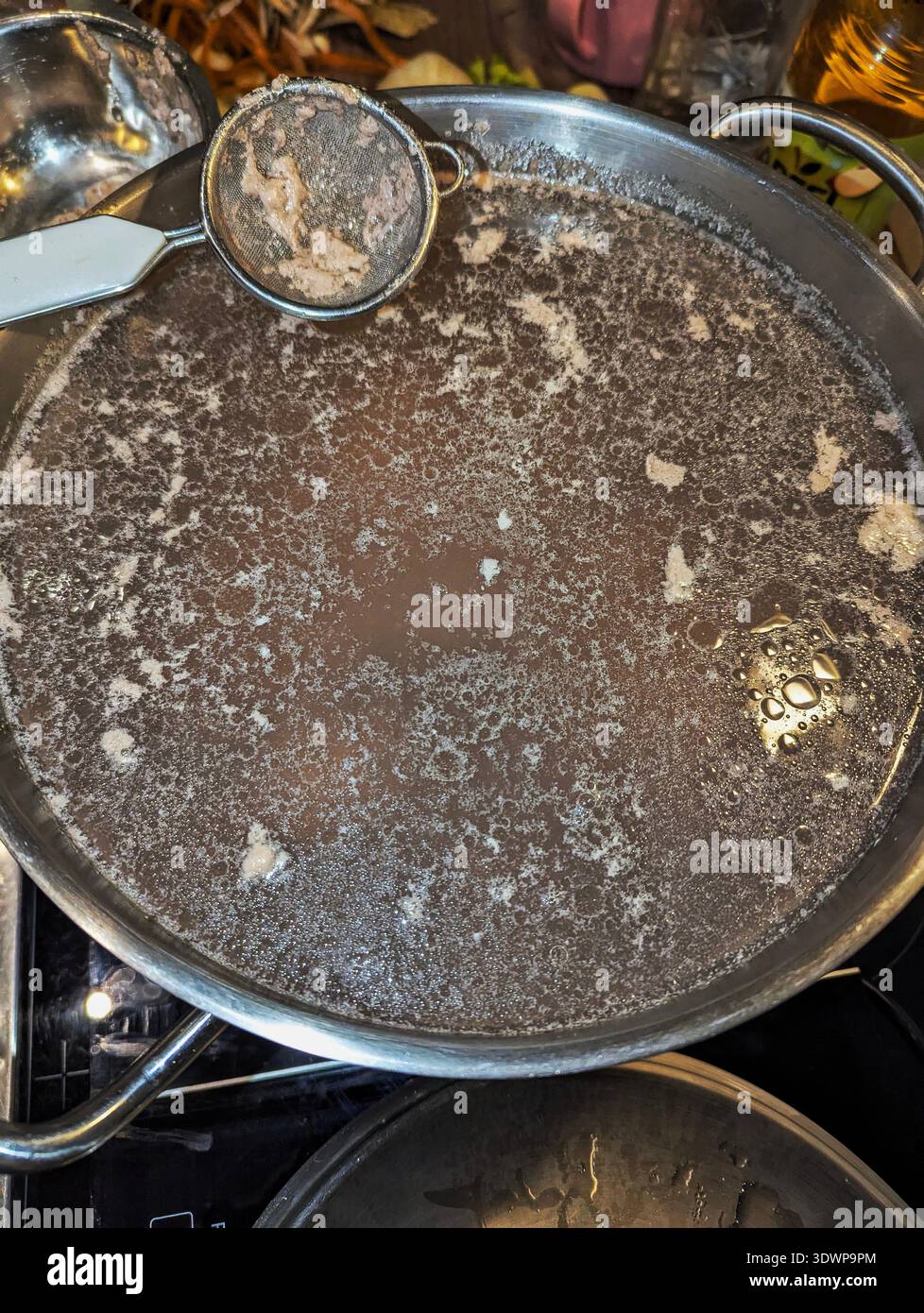 Using Metal Tool To Clear Impurities. Skimming Impurities From Bubbling ...