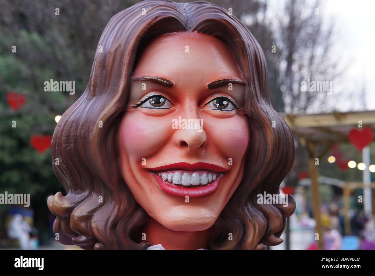 Giant cheerful caricature head of Melania Trump with flowing brown hair ...