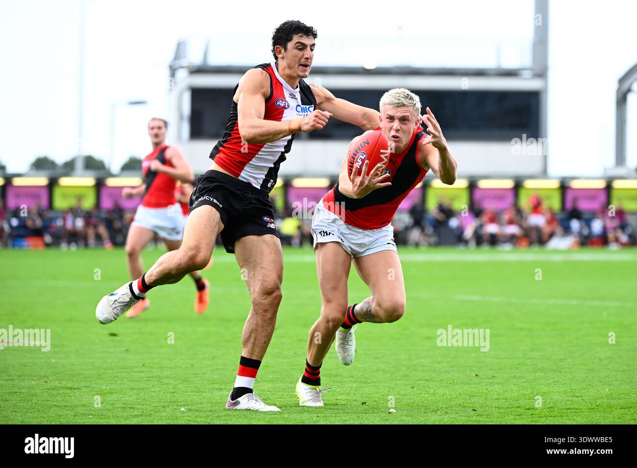 Nate Caddy of the Bombers marks the ball ahead of Anthony Caminiti of ...