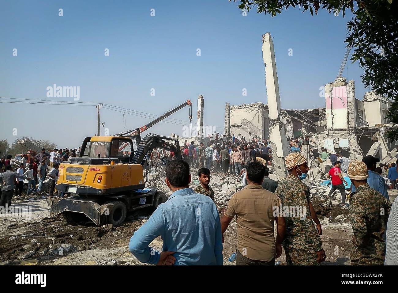 Rescue workers and residents search through the rubble in the aftermath ...