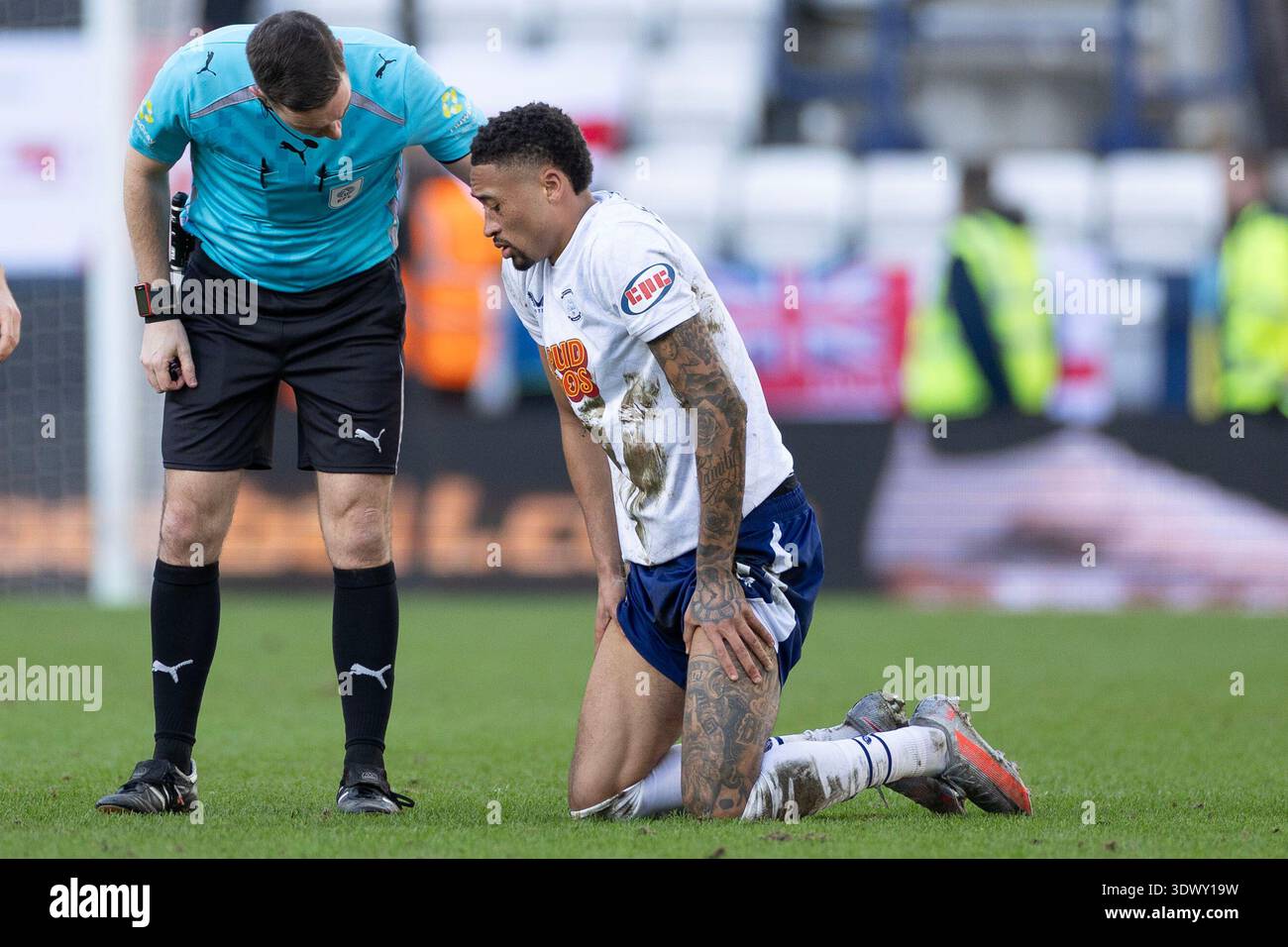 Referee, Ben Toner and Daniel Jebbison #9 of Preston North End F.C ...