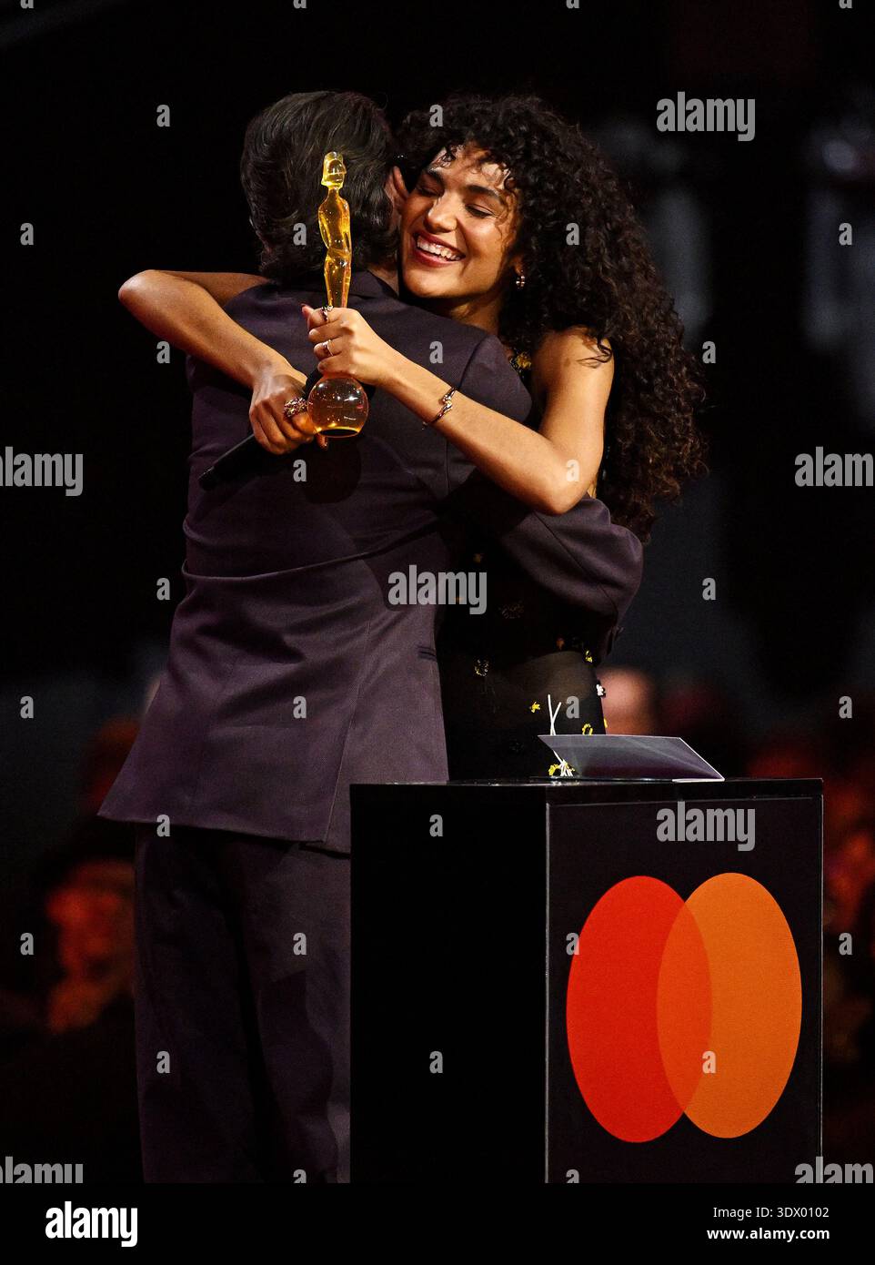 Olivia Dean receives the award for Best pop act from Designer Matthew ...