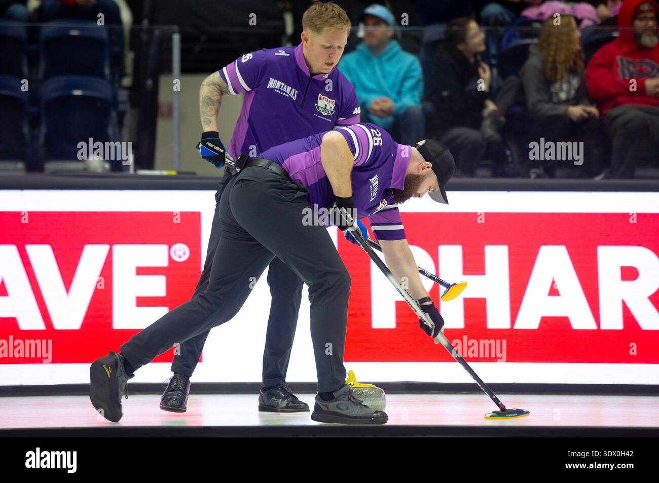 Team Yukon's Joe Wallinghan and Kerr Drummond sweep a stone during Draw ...