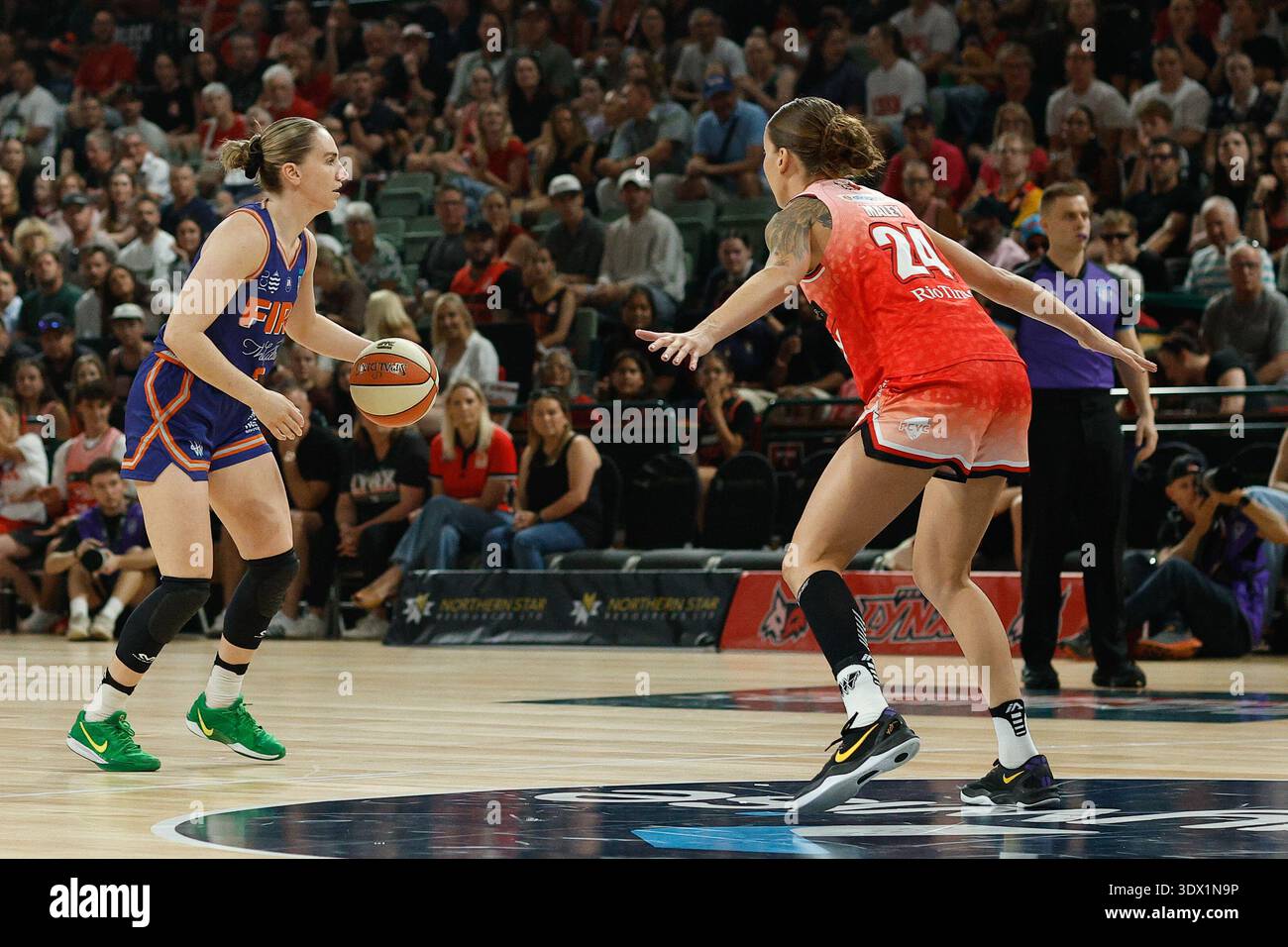 Courtney Woods of the Townsville Fire dribbles the ball guarded by ...