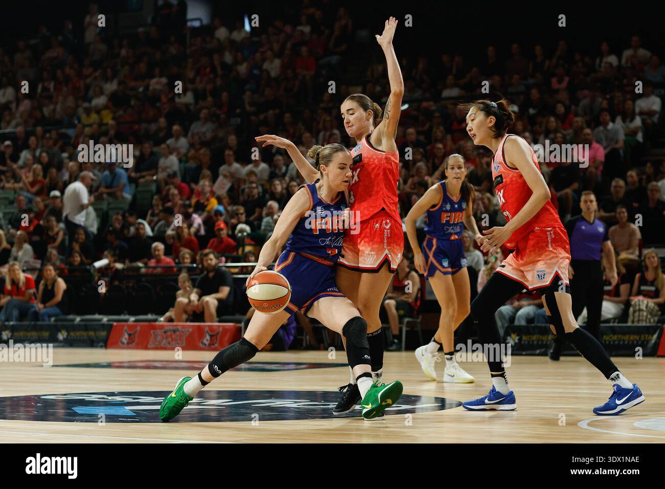 Courtney Woods of the Townsville Fire drives to basket but is blocked ...
