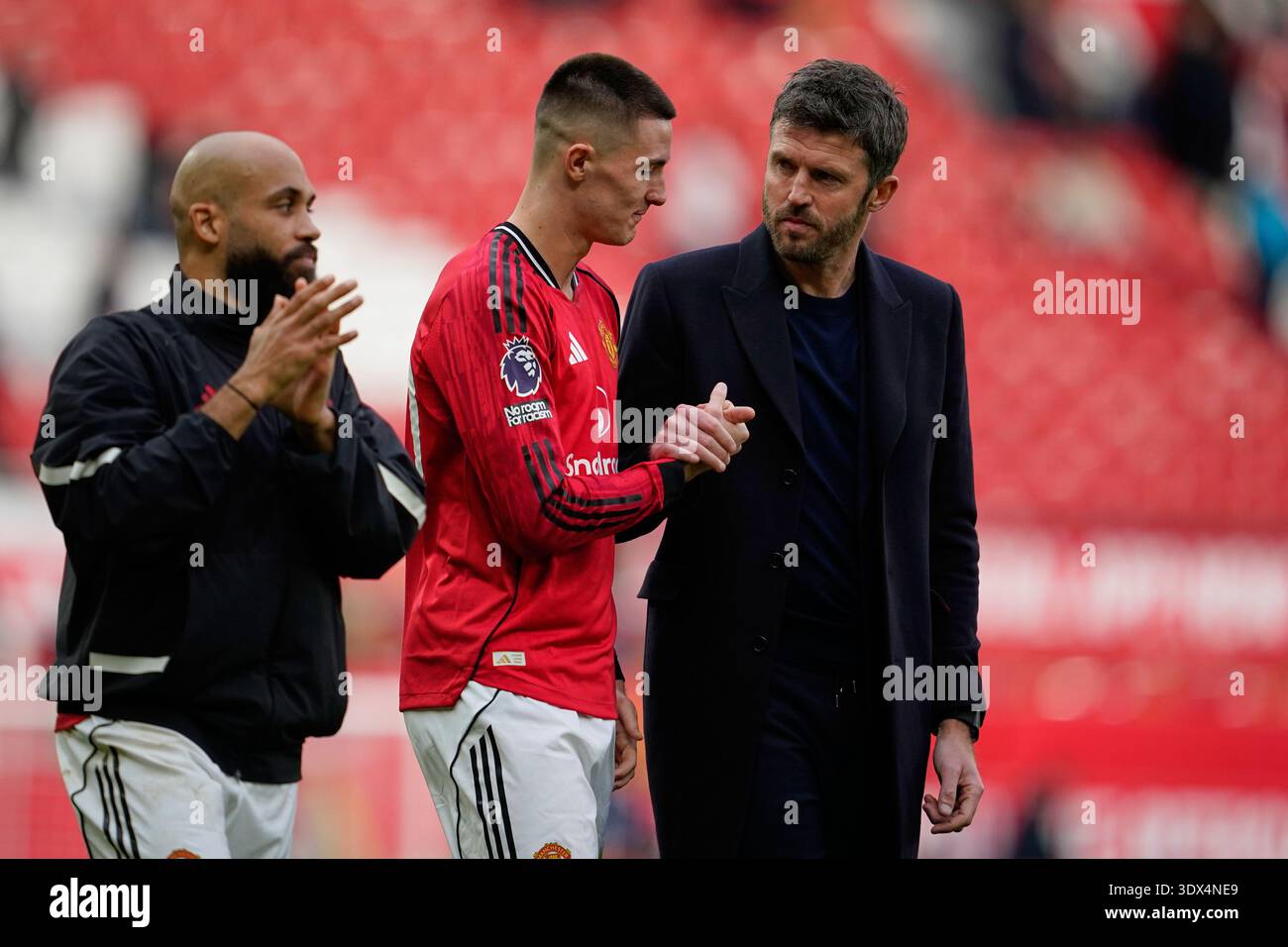 Manchester United's Benjamin Sesko shakes hands with coach Michael ...