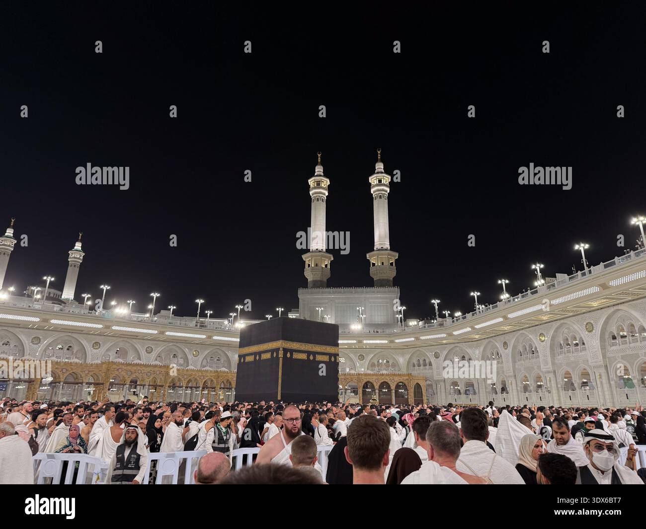 Pilgrims circling the Kaaba at Masjid al-Haram in Mecca during night ...
