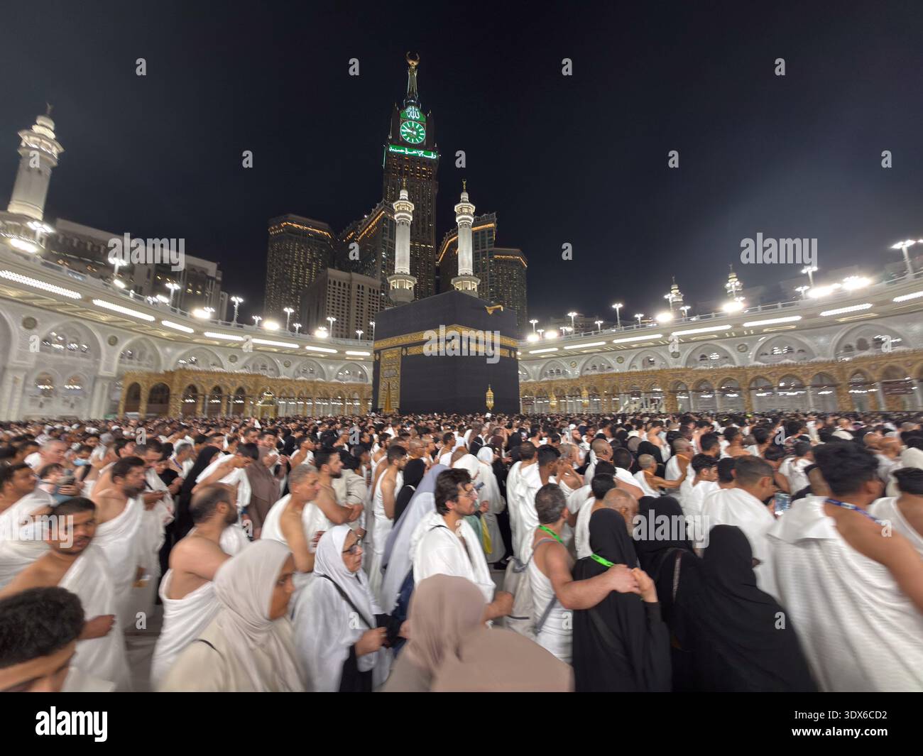 Pilgrims circling the Kaaba at Masjid al-Haram in Mecca during night ...