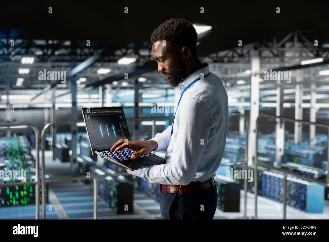 African american engineer in data center using laptop for neural ...