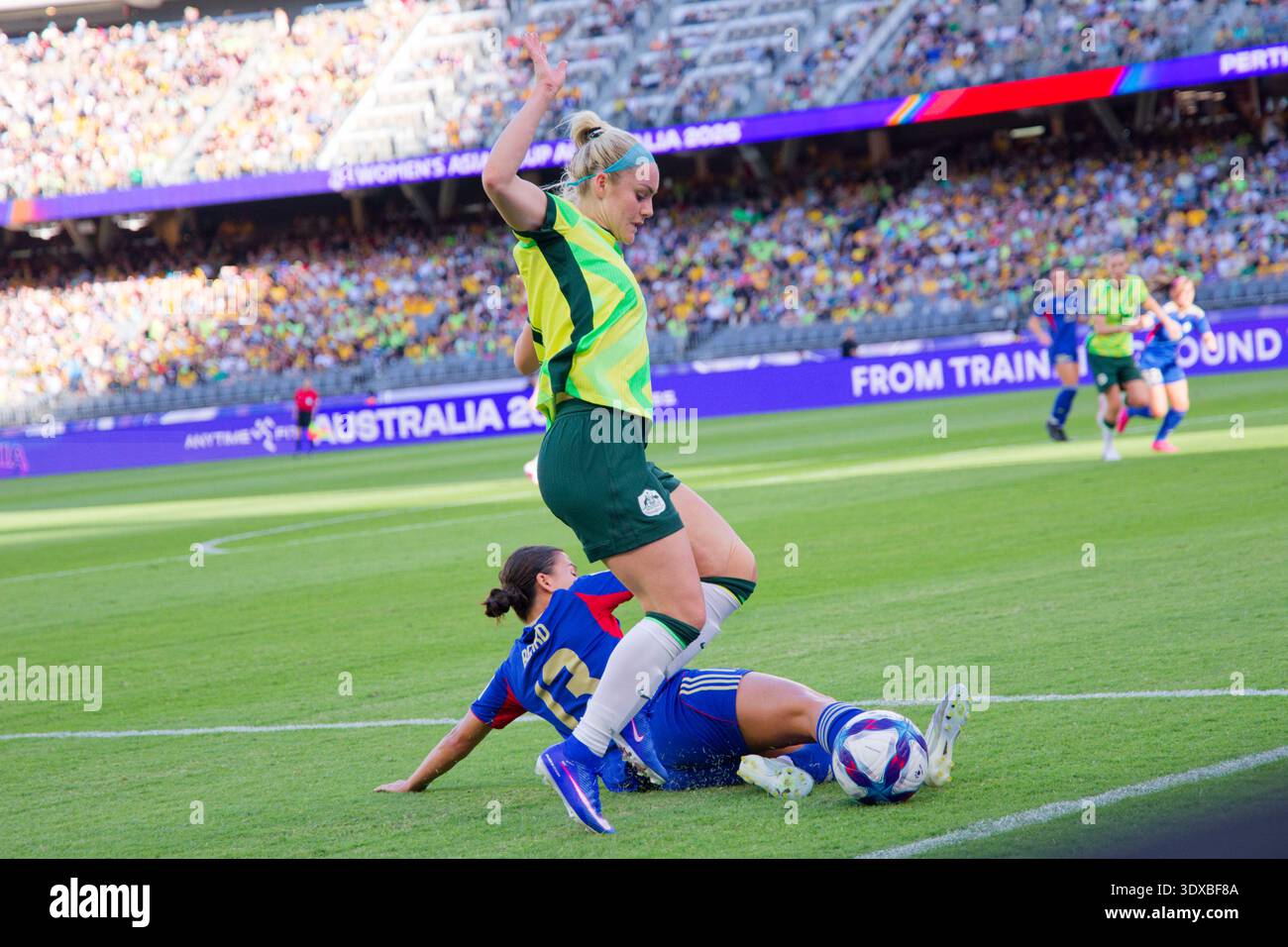 Angela Beard of the Philippines competes for the ball with Ellie ...