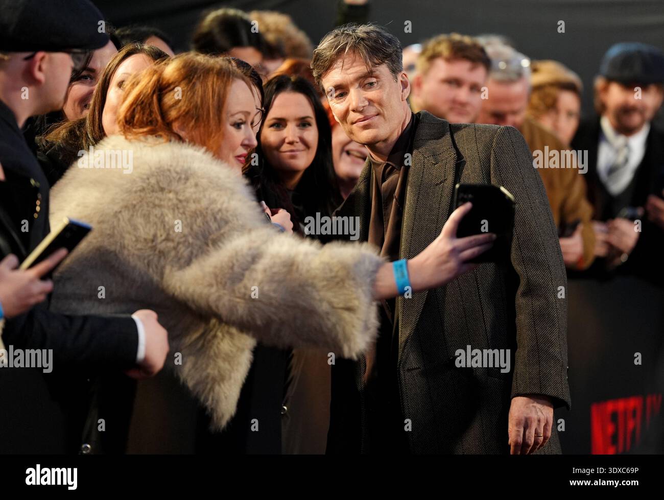 Cillian Murphy poses for a photo with a fan as he attends the global ...