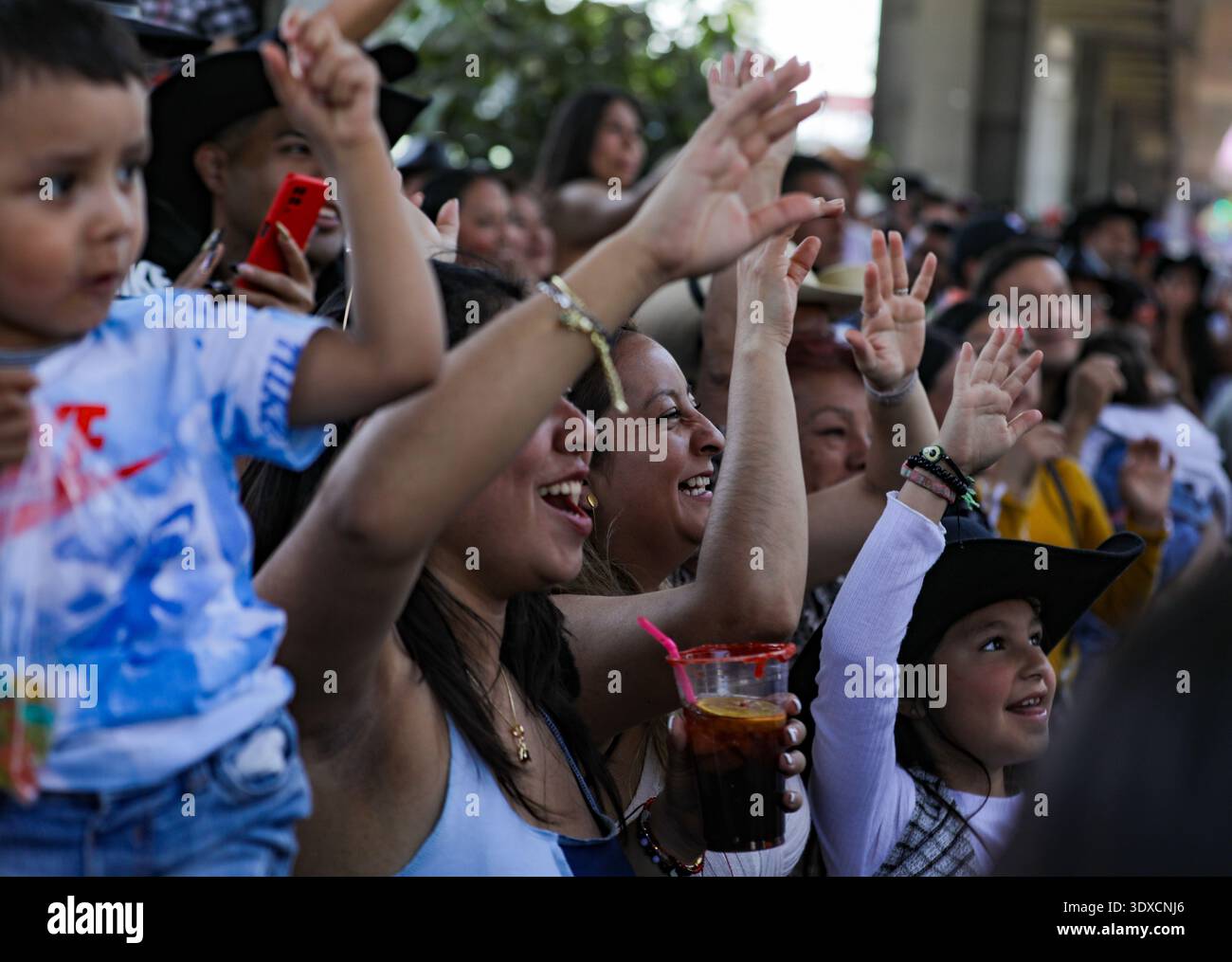 People attend the parade as part of the Santa Cruz Meyehualco carnival ...
