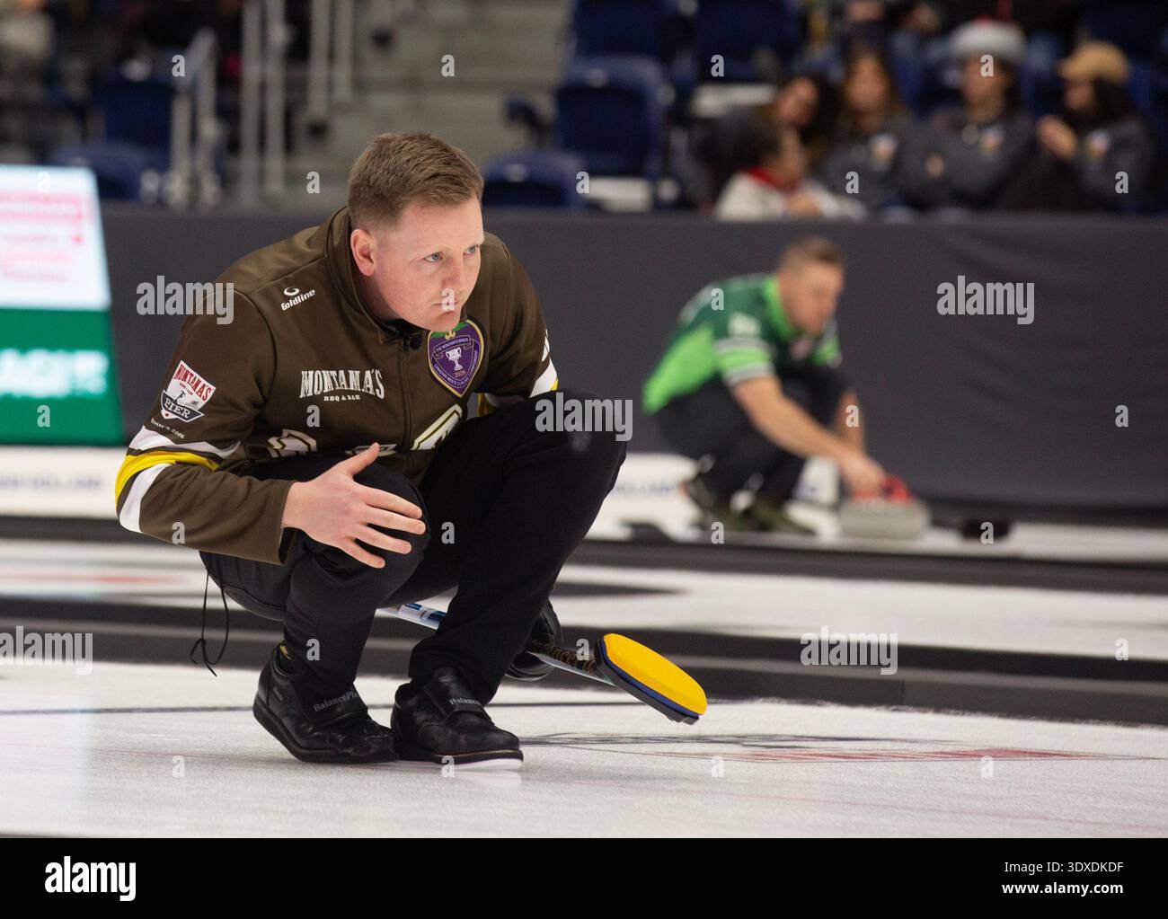 Braden Calvert, Skip of Manitoba-Calvert, watches the path of his stone ...