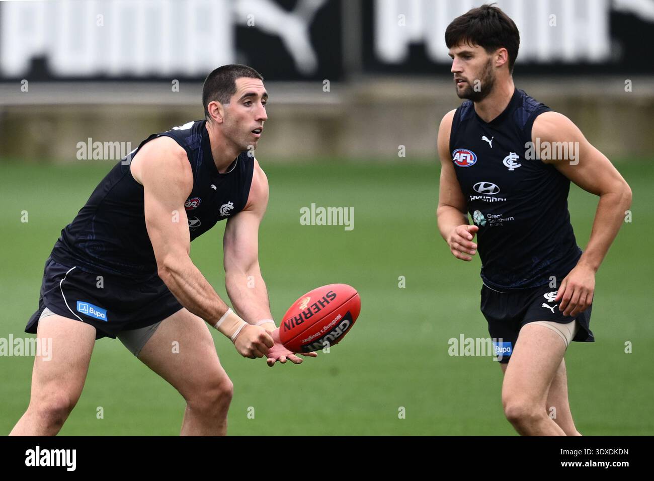 Jacob Weitering of Carlton (right) during an AFL training session at ...