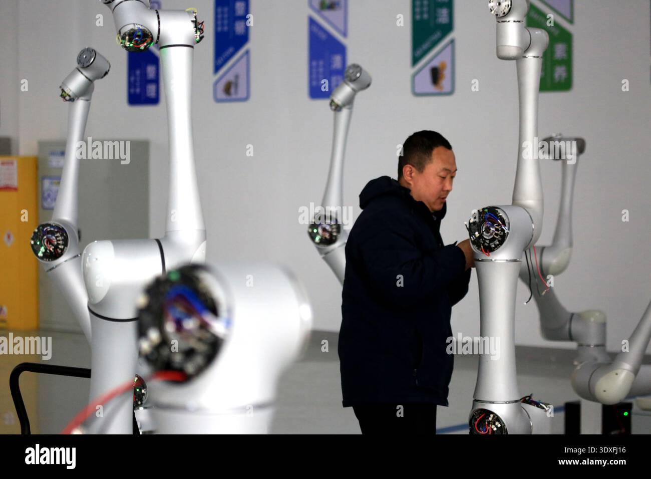 Technicians test collaborative robotic arms at a robot technology ...