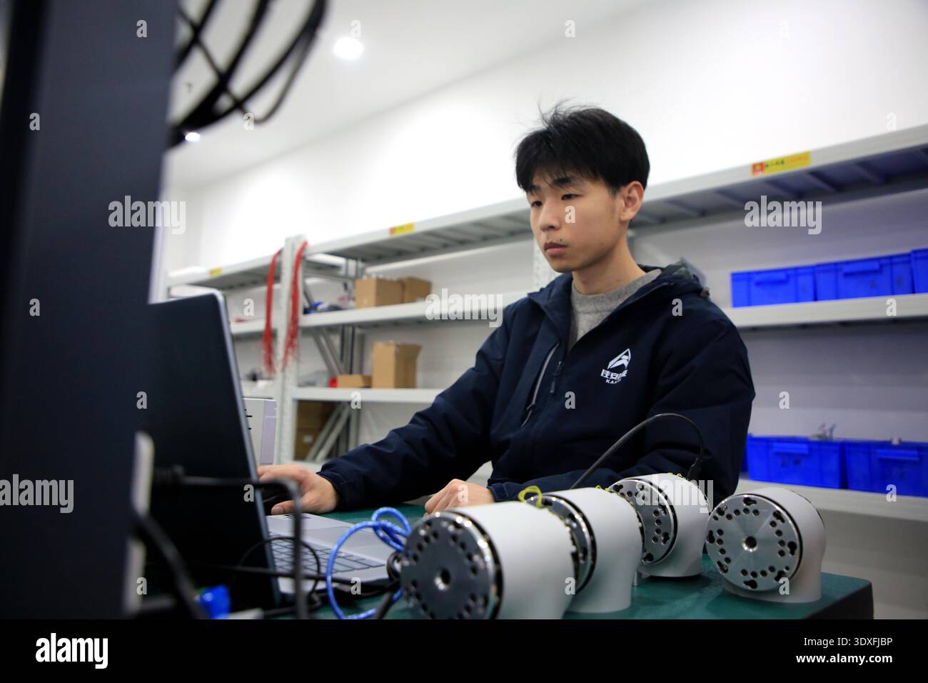 Technicians test collaborative robotic arms at a robot technology ...