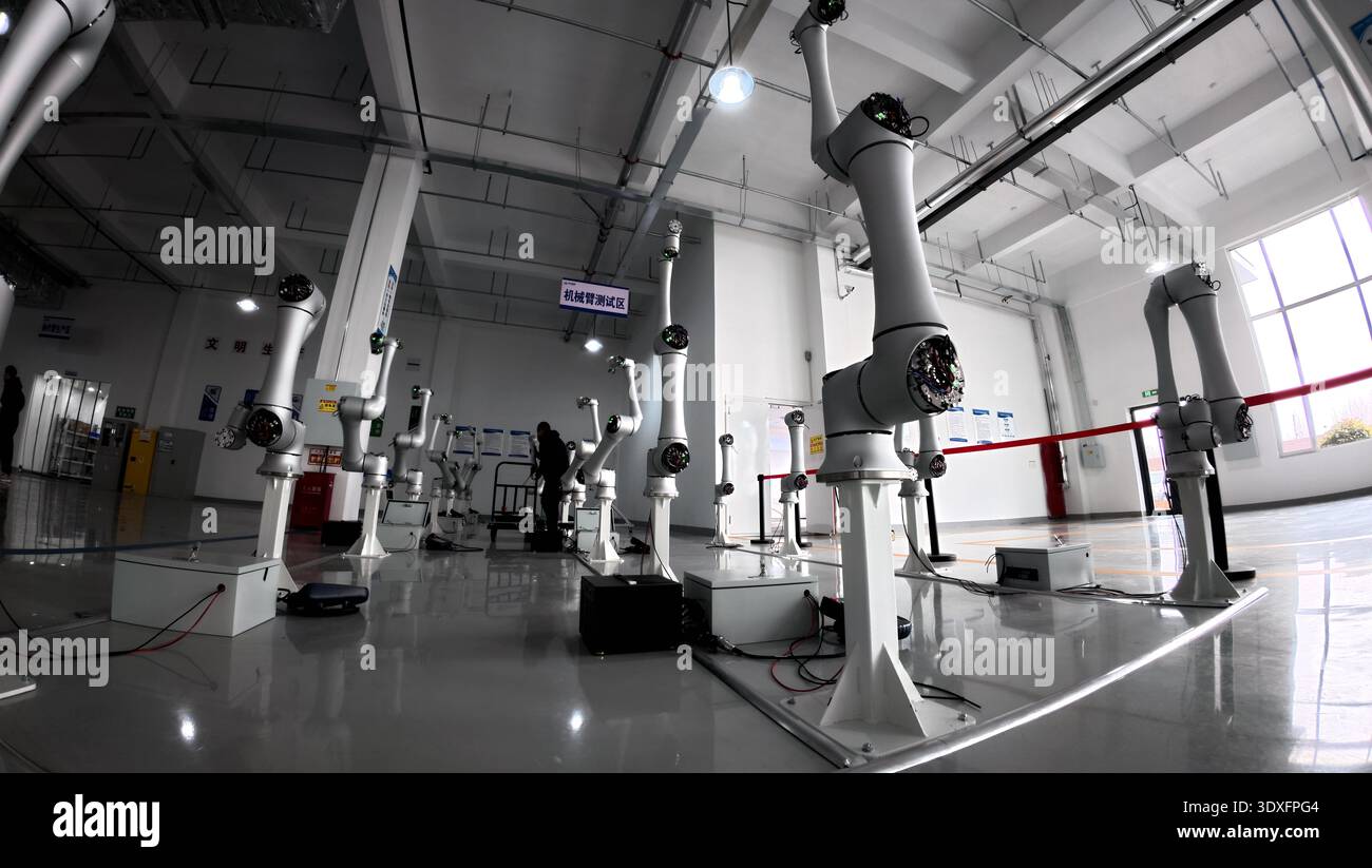 Technicians test collaborative robotic arms at a robot technology ...