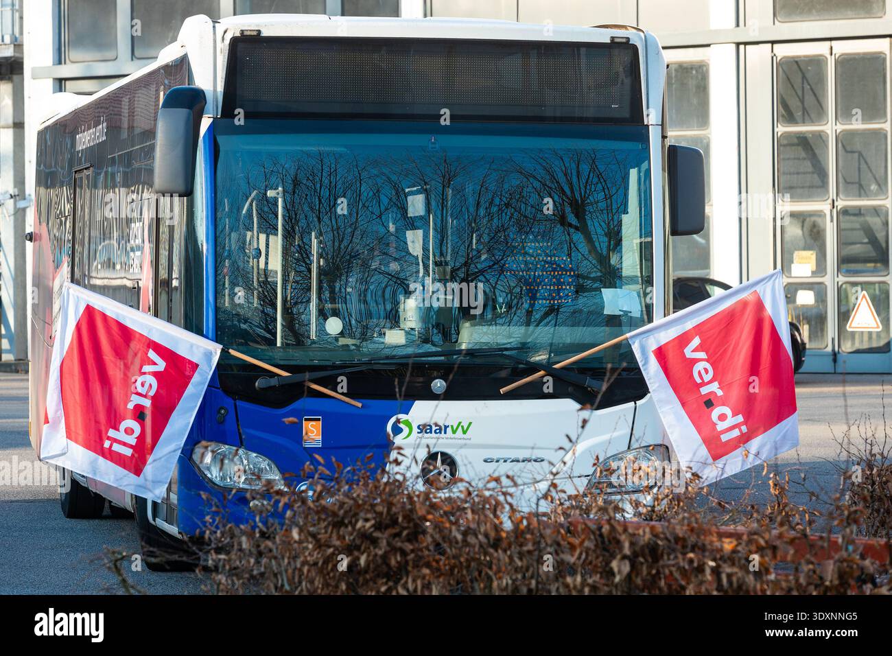 04 March 2026, Saarland, Saarbrücken: Two Verdi union flags are ...