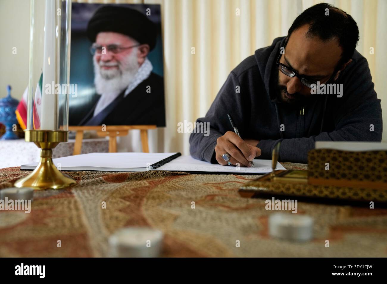A mourner writes condolence notes for the late Iranian Supreme Leader ...