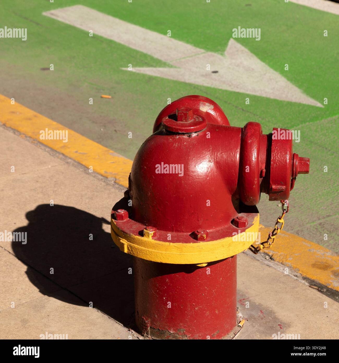 A red fire hydrant stands by a green cycling lane in Chicago, Illinois ...