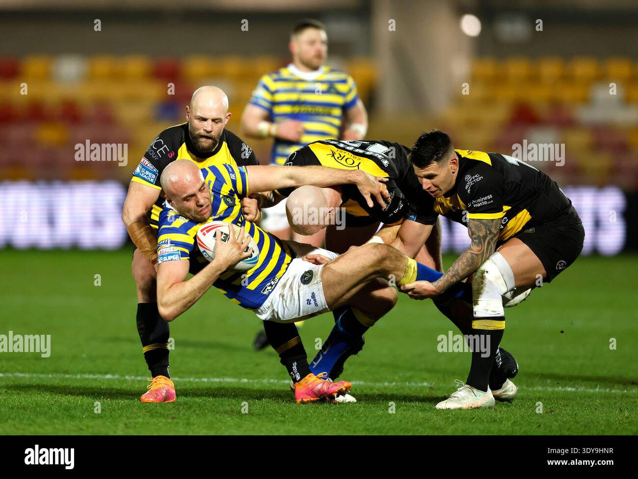 Warrington Wolves' James Harrison (centre) is tackled during the ...