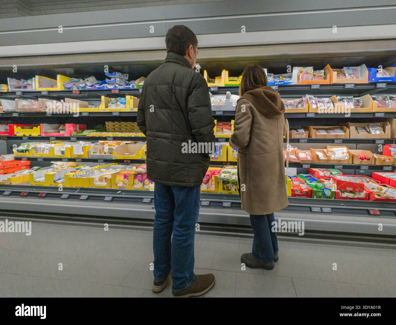23 February 2026, Hamburg: Customers look at the goods on a supermarket ...