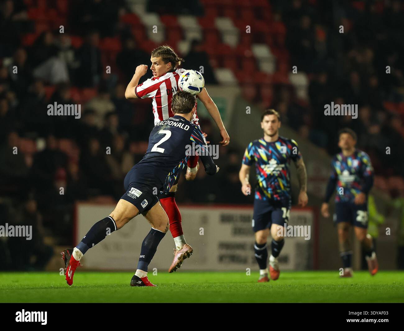 CHELTENHAM, ENGLAND - MARCH 6: Angus MacDonald of Barrow AFC wins a ...