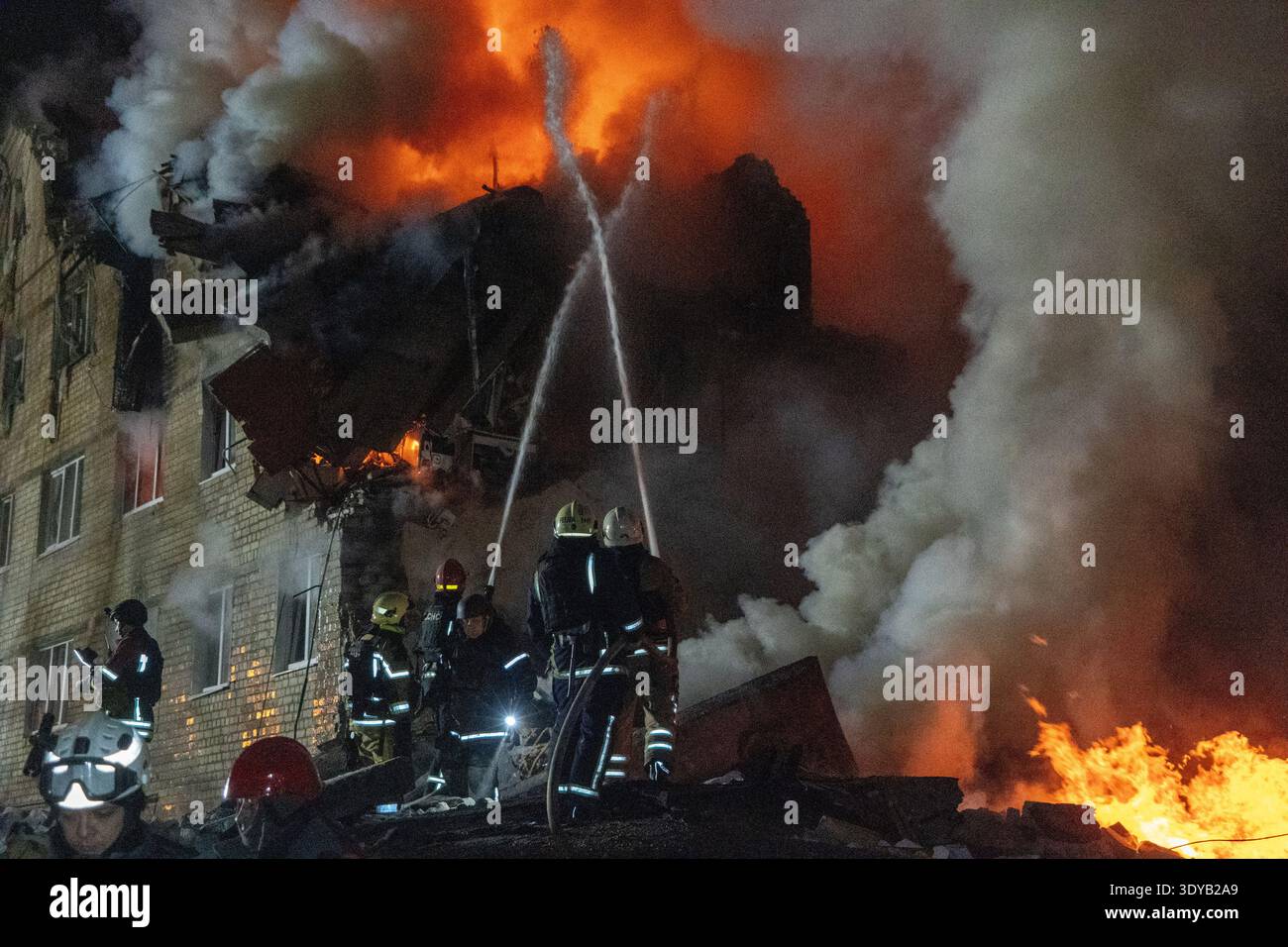 Firefighters battle a fire in an story apartment building following a ...
