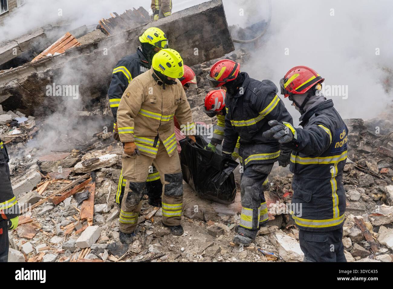 Rescuers carry a body that they extracted from under the rubble of an ...