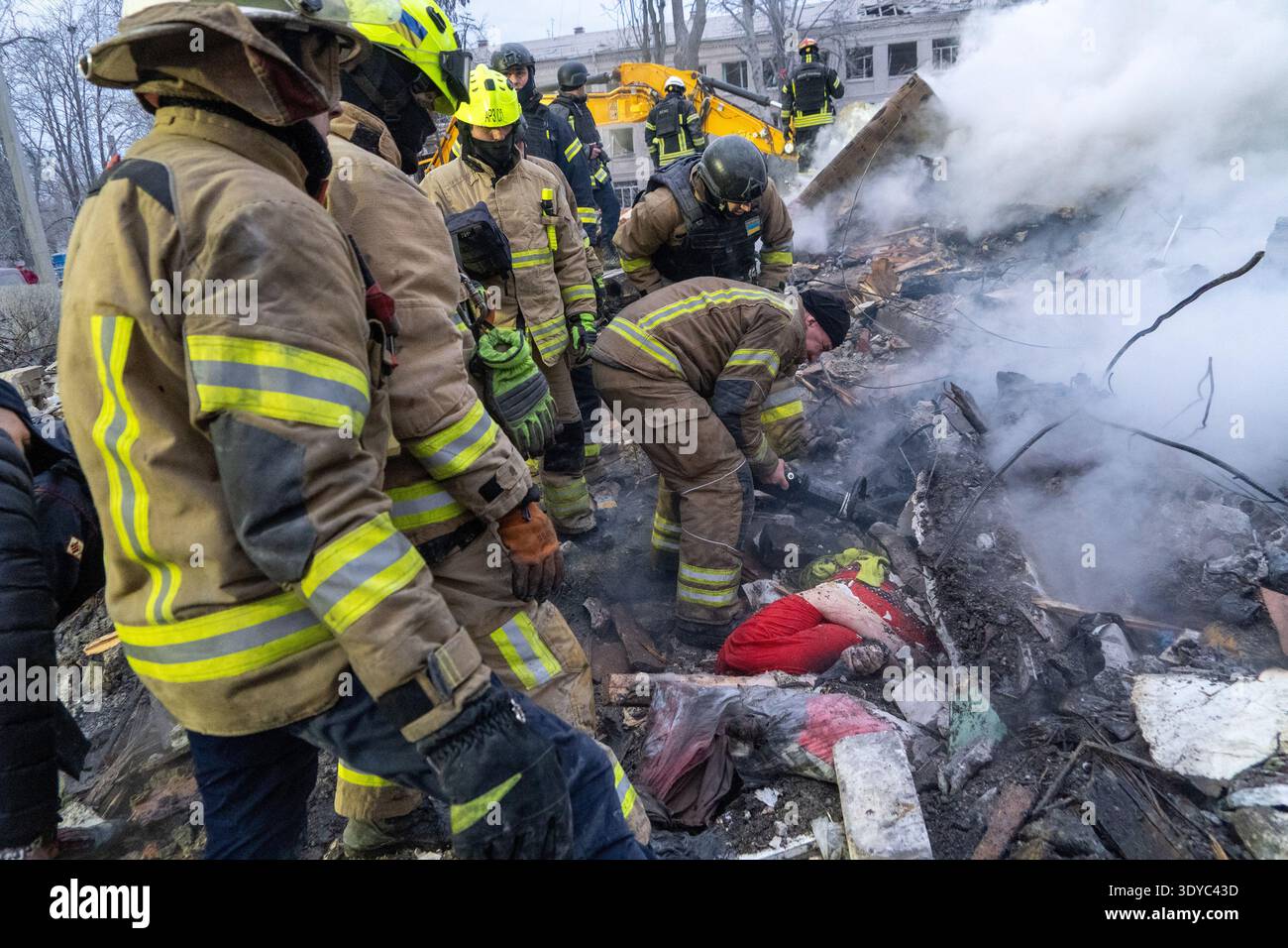 Rescuers clear the rubble as they search for bodies in the ruins of the ...
