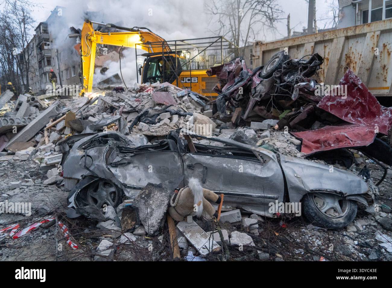 Rescuers clear the rubble of an apartment building following Russia's ...