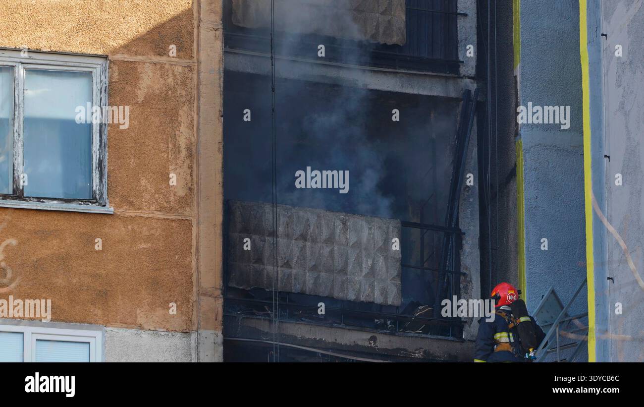Firefighter checking burning building hi-res stock photography and ...