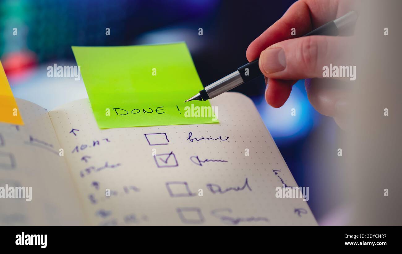 Checklist notebook completed task sticky note DONE. Hand marking ...