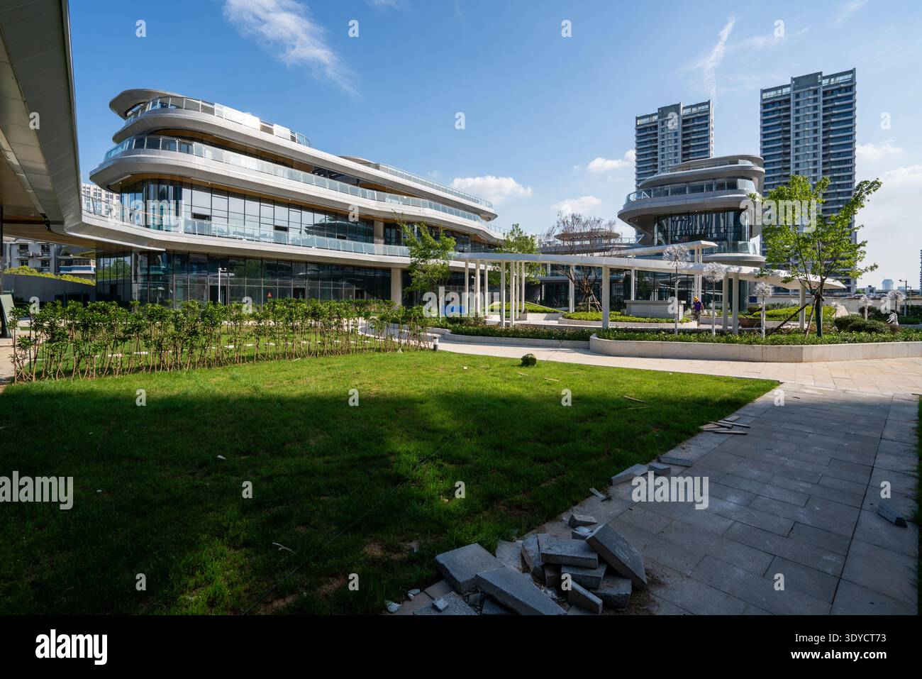 A horizontal landscape view of a modern corporate park with green lawns ...