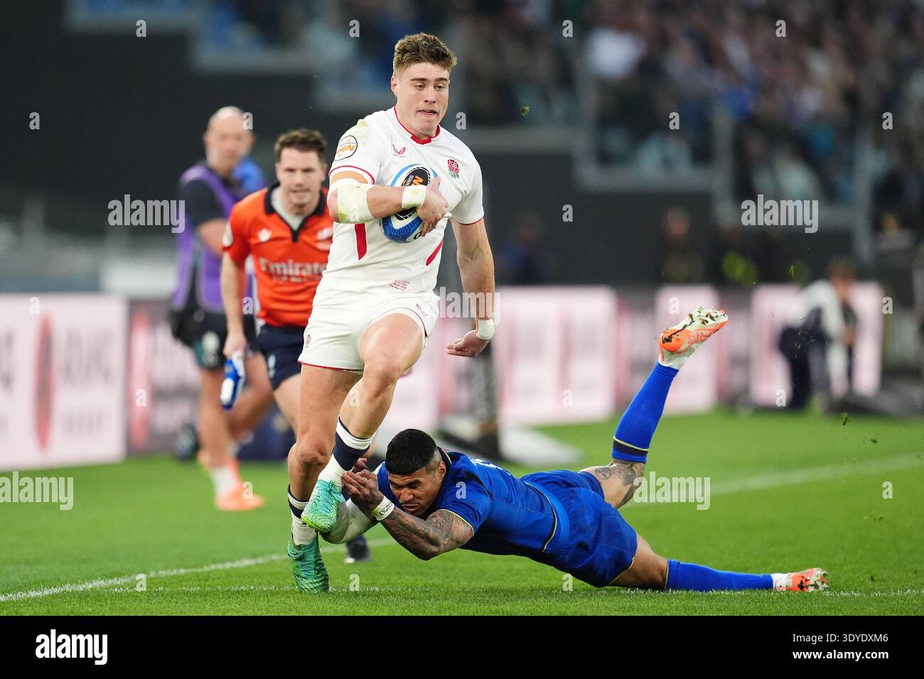 England's Seb Atkinson (left) is tackled by Italy's Monty Ioane during ...