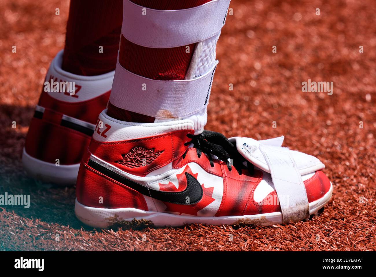 Canada’s Josh Naylor waits on deck wearing custom shoes featuring a ...