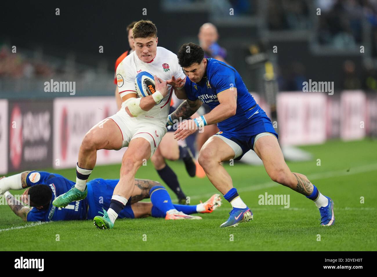 England's Seb Atkinson (left) is tackled by Italy's Tommaso Menoncello ...
