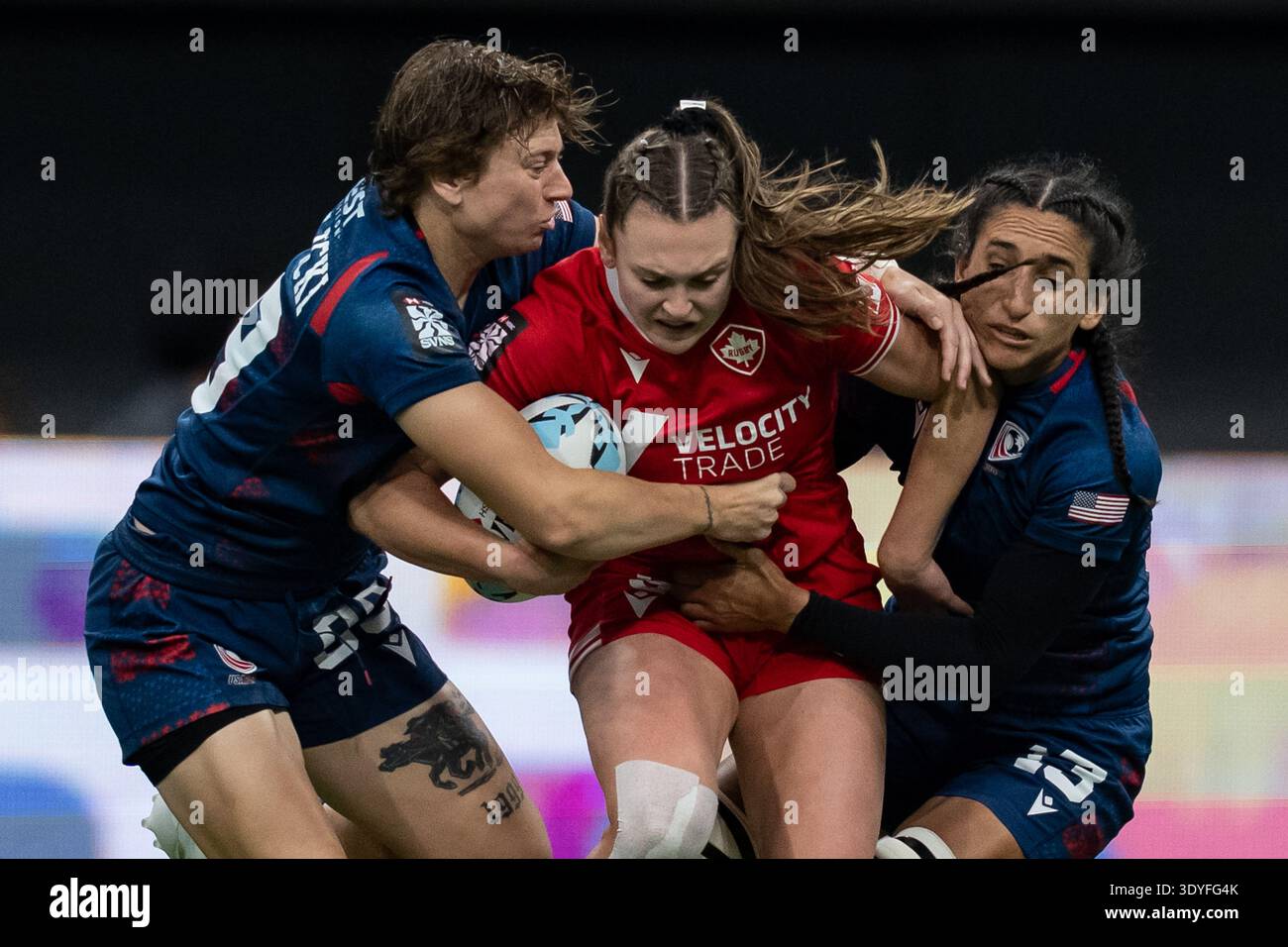 Canada's Savannah Bauder, centre, is stopped by USA's Autumn Czaplicki ...