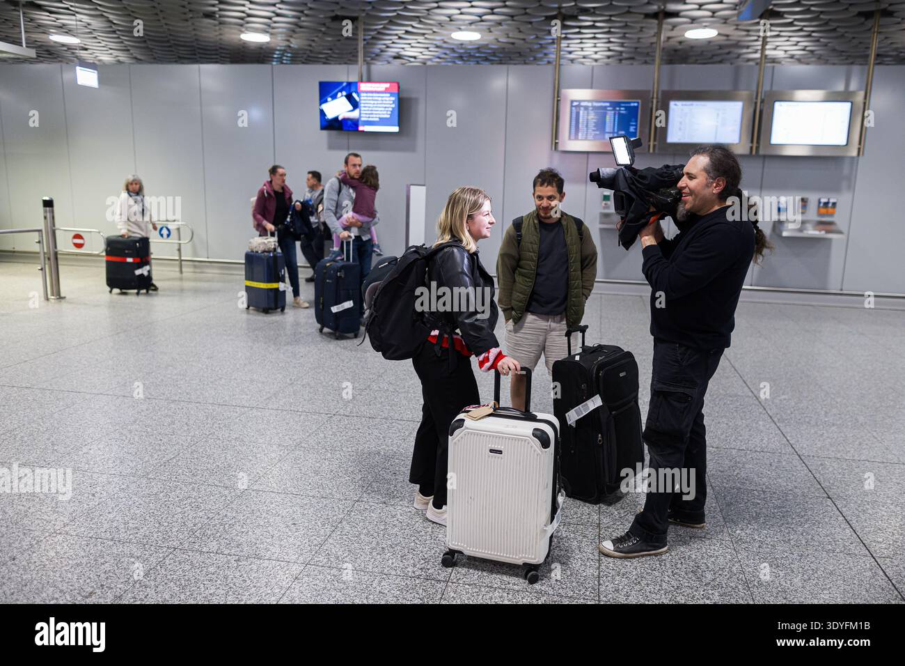Dubai tourists speak to a reporter after landing at Hanover-Langenhagen ...