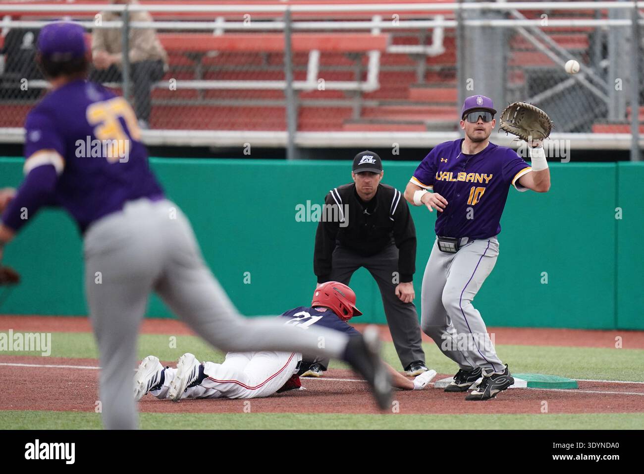 UAlbany infielder Logan Morris (10) receives the throw from pitcher ...