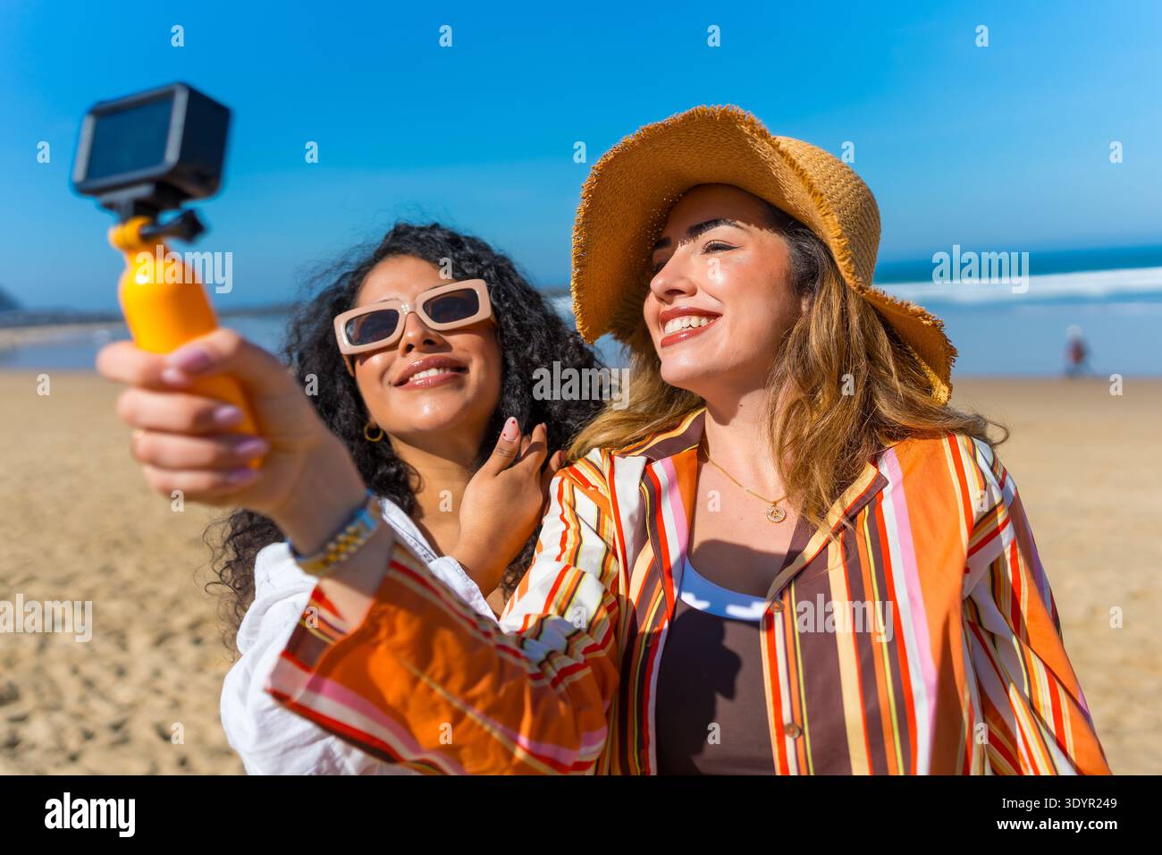 Happy women friends recording selfie video on summer beach vacation ...