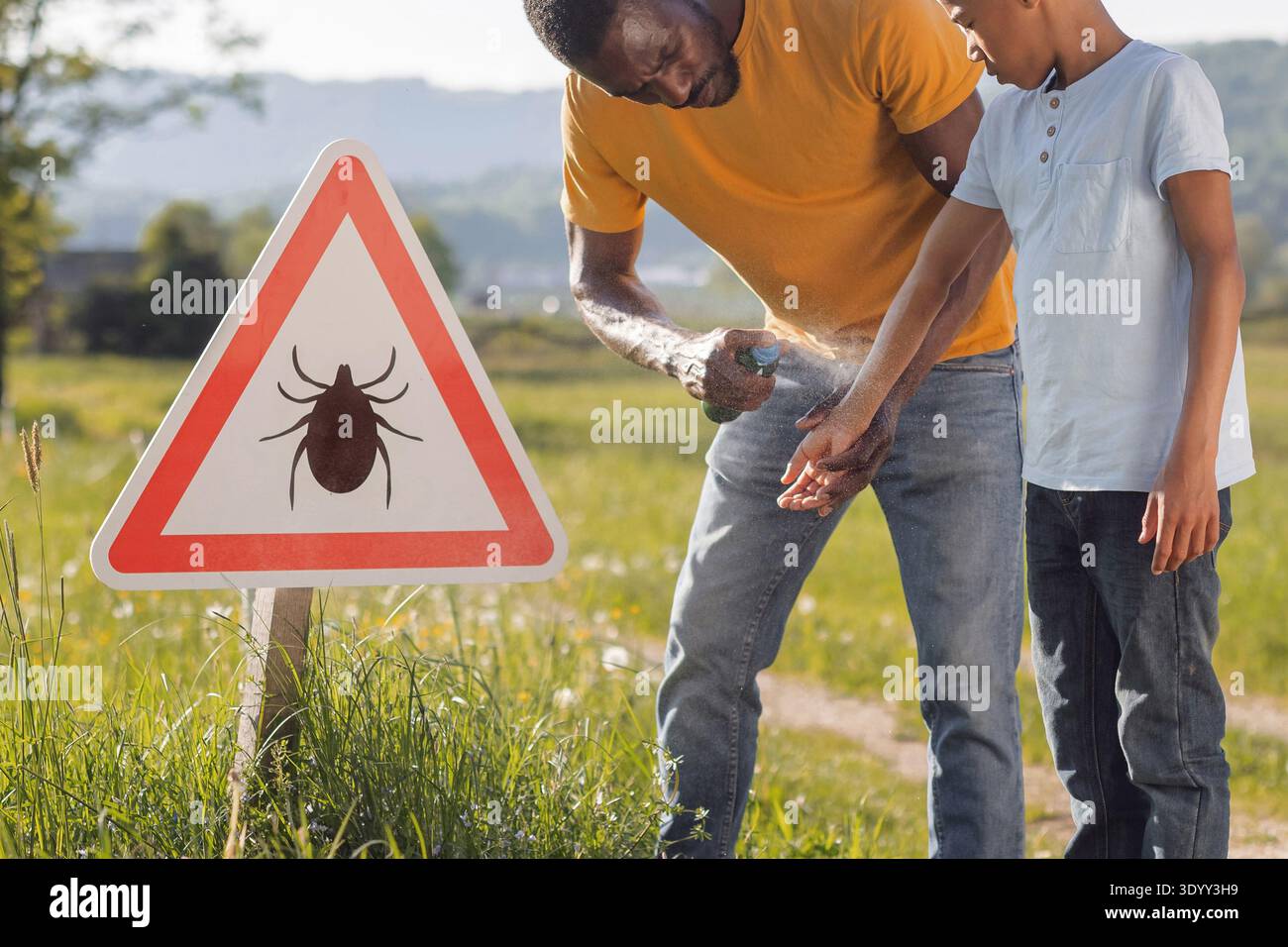 Family notices tick warning sign during hike and applies repellent ...